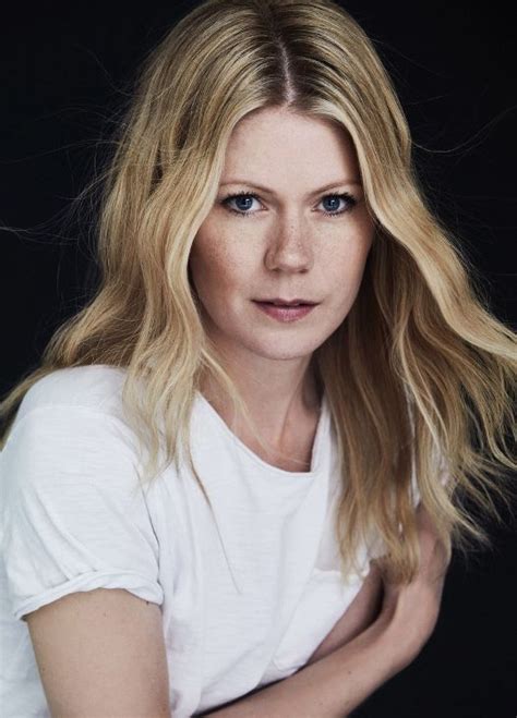 A Woman With Long Blonde Hair Posing For A Photo