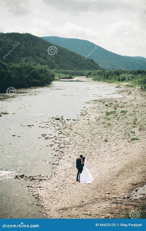 Elegant Gentle Stylish Groom And Bride Near River With Stones Wedding Couple In Love Stock