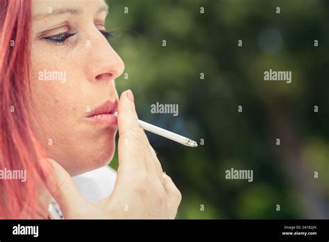 Closeup Portrait Of A Pretty Red Haired Woman Being Spit Out Of