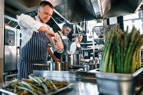 Premium Photo Boiling And Adding Ingredients Kitchen Workers Is Together Preparing The Food