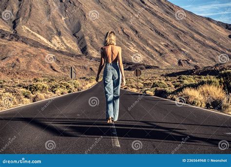 Woman Topless Traveler In Jeans Walking Away On The Street Over The