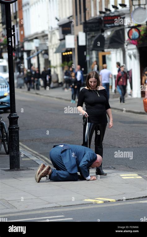 A Man Being Publicly Humiliated By A Dominatrix In The Streets Of Soho Where He Was Made To