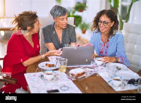 Meeting Of Middle Age Women Having Lunch And Drinking Coffee Mature