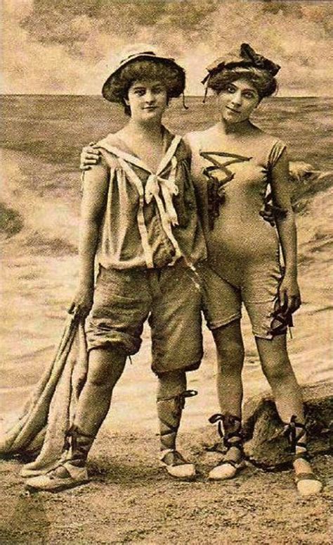 Two People Standing Next To Each Other On A Beach With Water In The