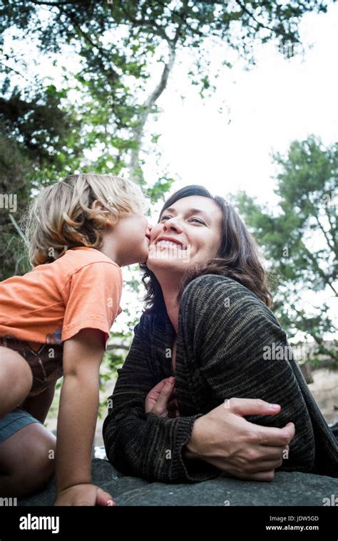 Son Kissing Mother In Forest Stock Photo Alamy