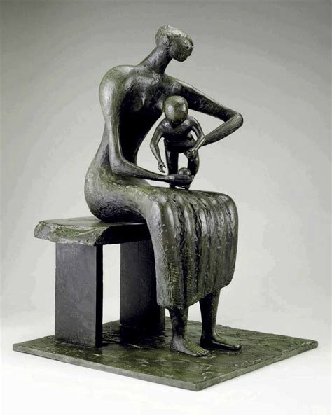 A Bronze Statue Sitting On Top Of A Wooden Bench Next To A Black Box