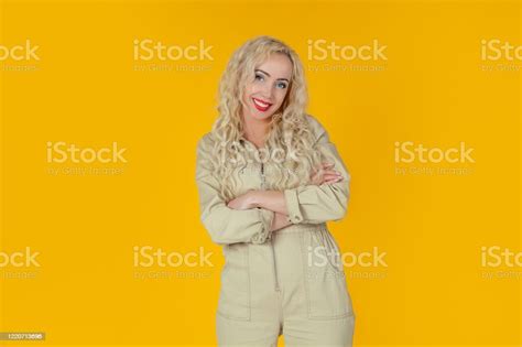 Portrait Of A Joyful And Cheerful Cute European Curlyhaired Blonde Woman Who Jokes Cheerfully