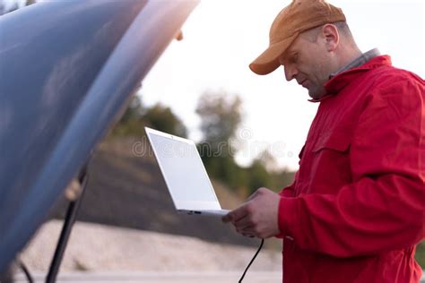 Emergency Roadside Assistance Road Assistance Worker In Uniform Trying
