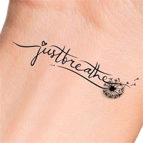 A Wrist Tattoo With The Word Just Breathe On It And Dandelions In Black Ink