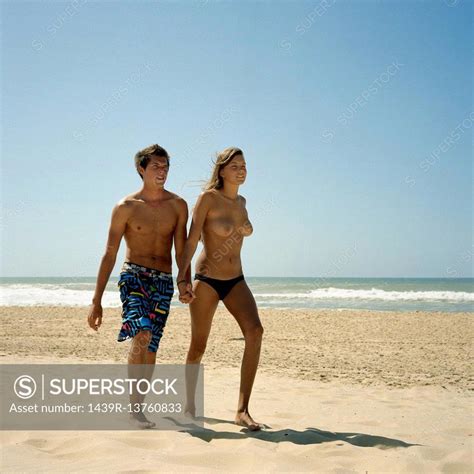 Couple Walking On Empty Beach Superstock