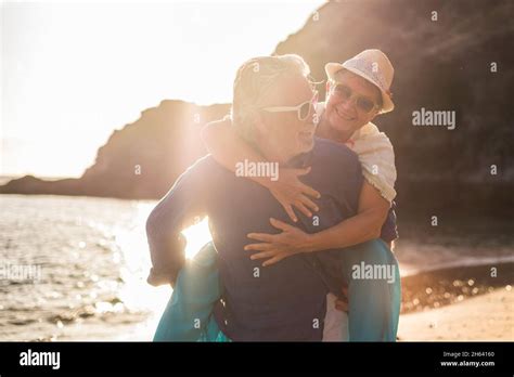 old people active couple enjoy outdoor leisure activity together playing and carrying woman in