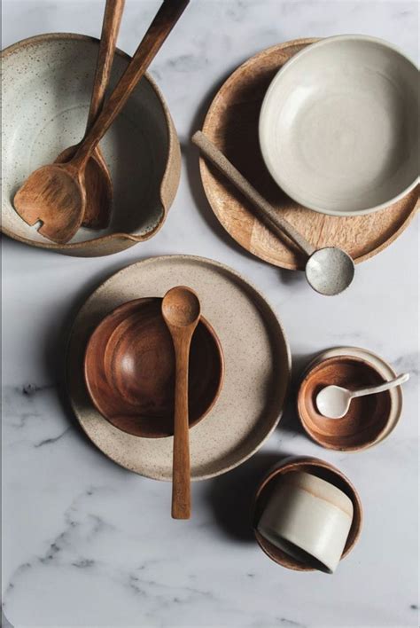 Wooden Spoons Bowls And Plates On A Marble Table