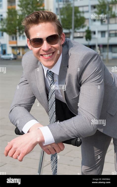 Man In Grey Suit With Sunglasses And Scooter Hi Res Stock Photography