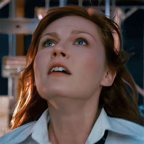 A Woman With Long Hair And Blue Eyes Looking Up At Something In The Air Above Her Head