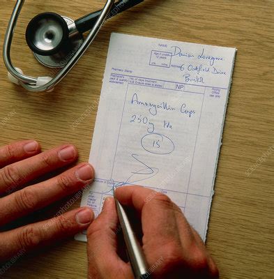 Doctor Signing A Prescription For Amoxycillin Stock Image M920 0437