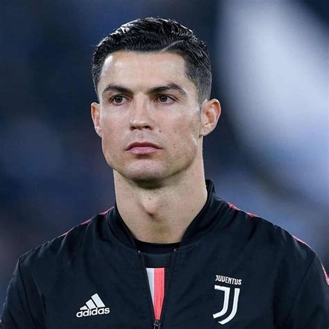 A Soccer Player Is Standing In Front Of The Camera With His Head Turned