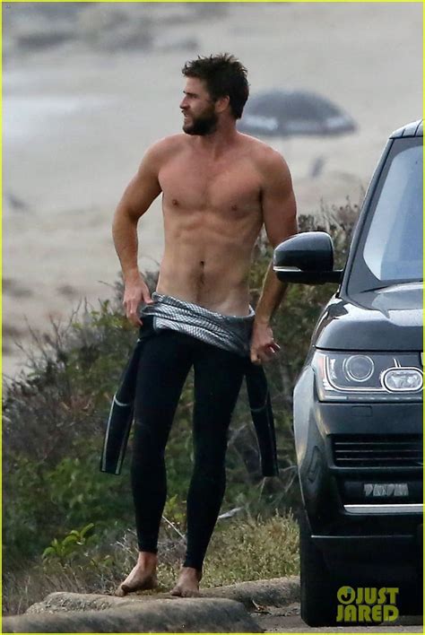 Liam Hemsworth Bares Ripped Abs While Stripping Out Of Wetsuit Photo