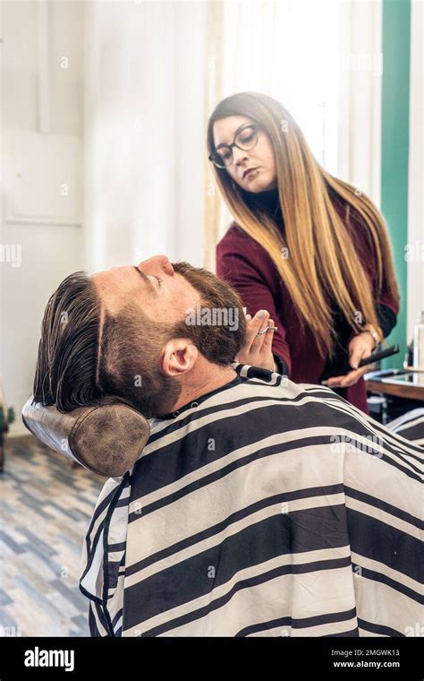 Female Hairdresser Trimming Hipster Clients Hair With Scissors Hipster Man At Barbershop