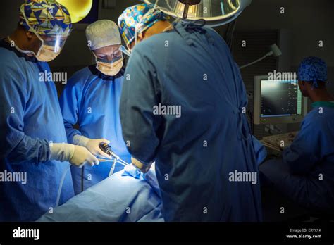 Surgeons Performing Surgery In Operating Room Stock Photo Alamy