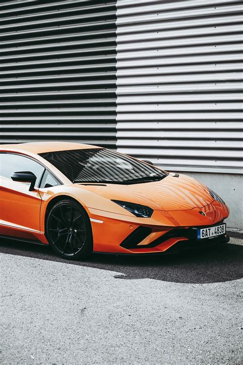 HD Wallpaper Orange Lamborghini Sports Coupe Parked Near Corrugated