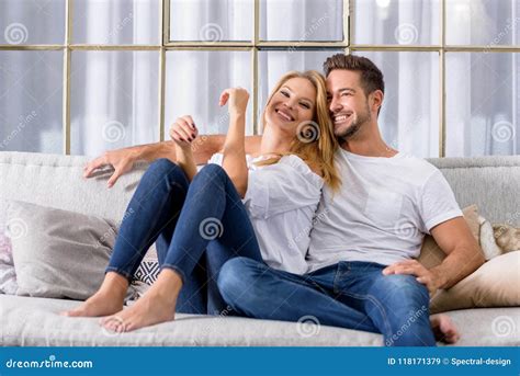 Young Couple Cuddling On The Sofa Stock Image Image Of Passion Couch 118171379