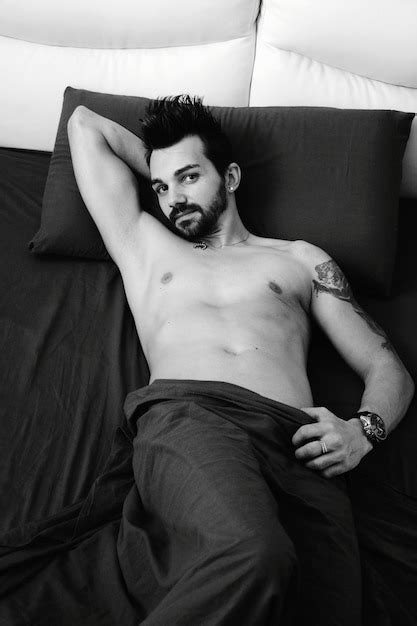 Premium Photo Portrait Of Shirtless Man Lying On Bed