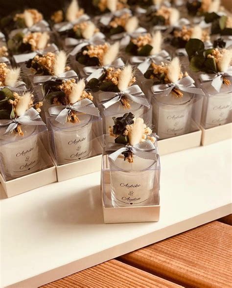 Many Small Glass Containers With Flowers In Them On A Counter Top Next