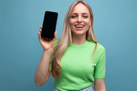 Premium Photo Cute Blond Girl In Casual Outfit Holding Smartphone With Screen Forward Mockup