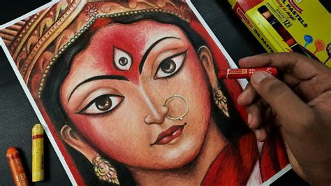 A Drawing Of A Woman S Face Is Shown With Crayons Next To It