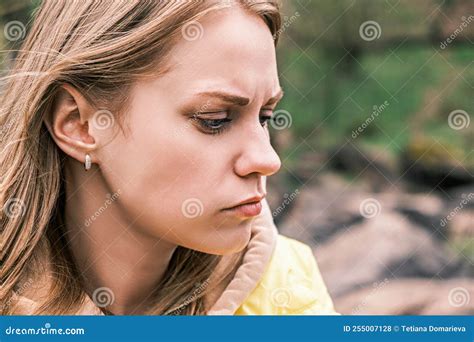 Side View Portrait Of A Young Serious Upset Woman Clenching Her Teeth With A Tense Jaw Stock