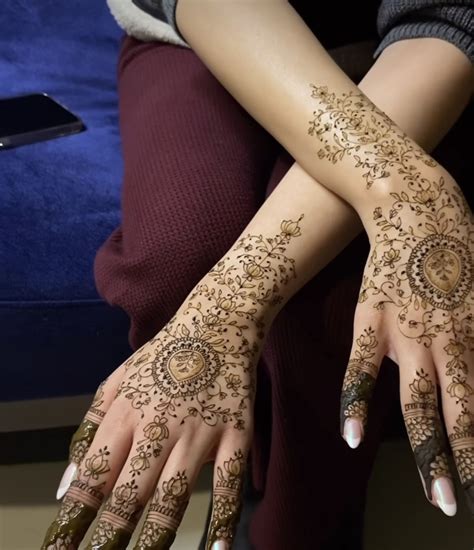 Two Women With Henna Tattoos On Their Hands