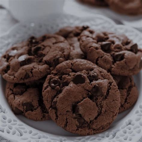 Chocolate Chip Cookies On A White Plate With A Cup Of Coffee
