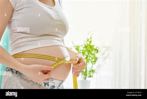 Pregnant Woman Measuring Her Belly Stock Photo Alamy