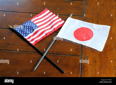 Flags Of The United States And Japan On A Wooden Surface American