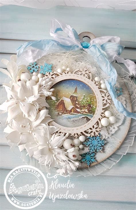 A White Wreath Decorated With Blue And White Snowflakes On Top Of A