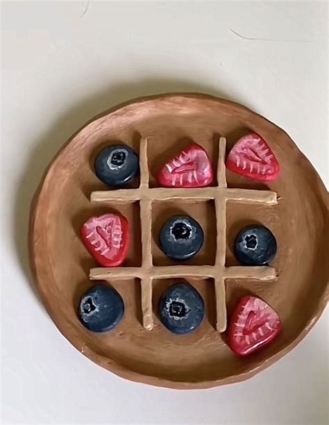 A Wooden Bowl Filled With Blueberries And Strawberries On Top Of A