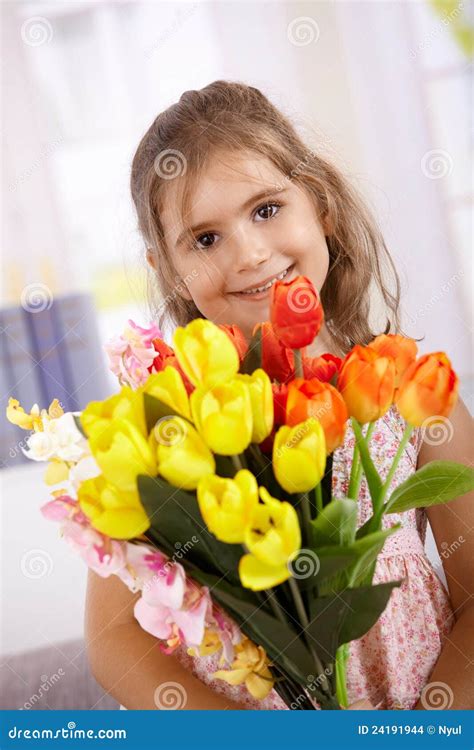 Petite Fille Mignonne Avec Le Bouquet Du Sourire De Fleurs Photo Stock