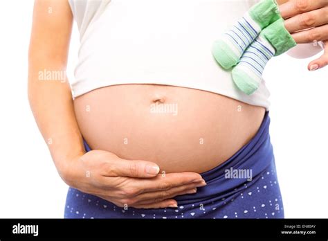 Pregnant Woman Holding Baby Shoes Over Bump Stock Photo Alamy