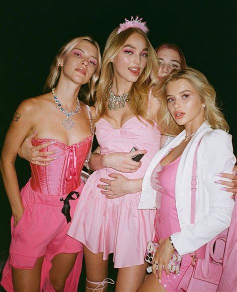 Three Women In Pink Dresses Posing For The Camera