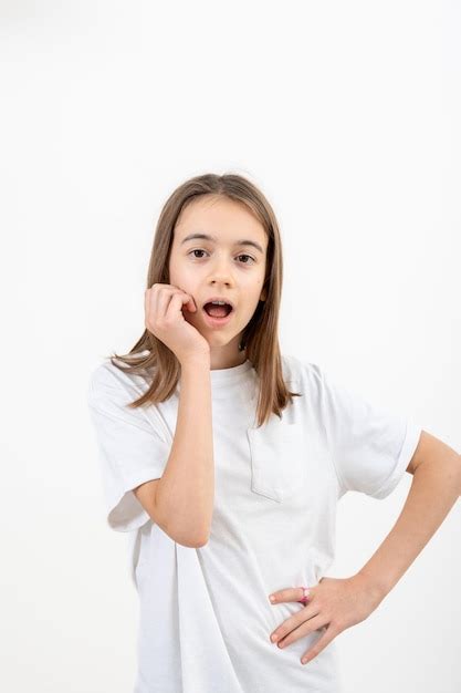 Premium Photo A Girl With Mouth Wide Open Holds Her Hand Near Face On A White Background