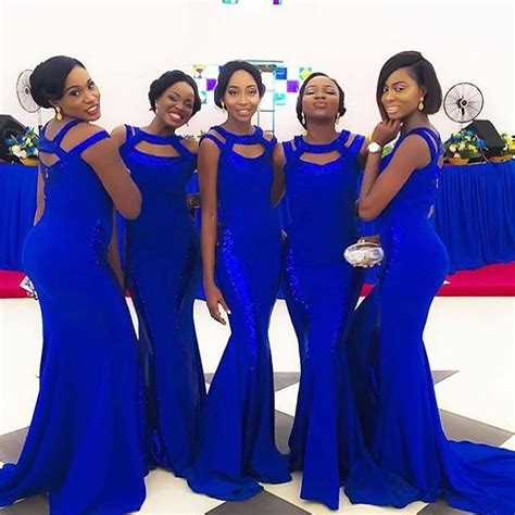 Four Women In Blue Dresses Posing For The Camera