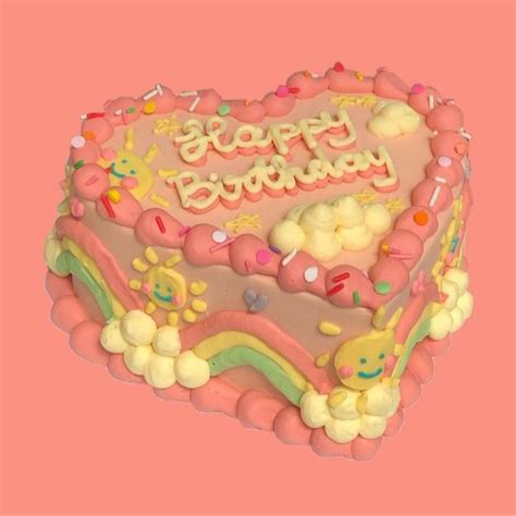 A Heart Shaped Birthday Cake On A Pink Background