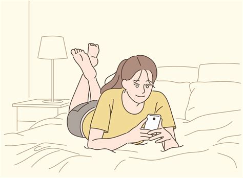 una niña acostada cómodamente en su cama y mirando su teléfono celular