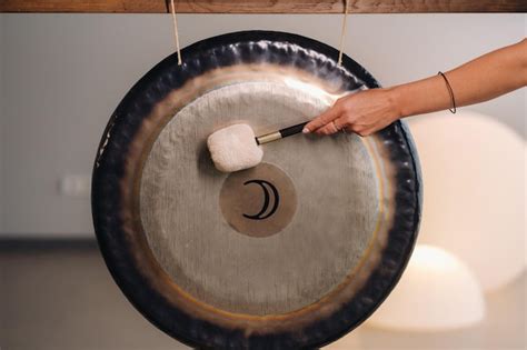Premium Photo Closeup Of A Womans Hand Pounding A Gong With A Hammer Gong And Hand Beater For