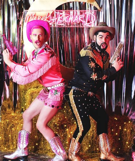 Two People Dressed In Costume Posing For A Photo Together With Tinsel