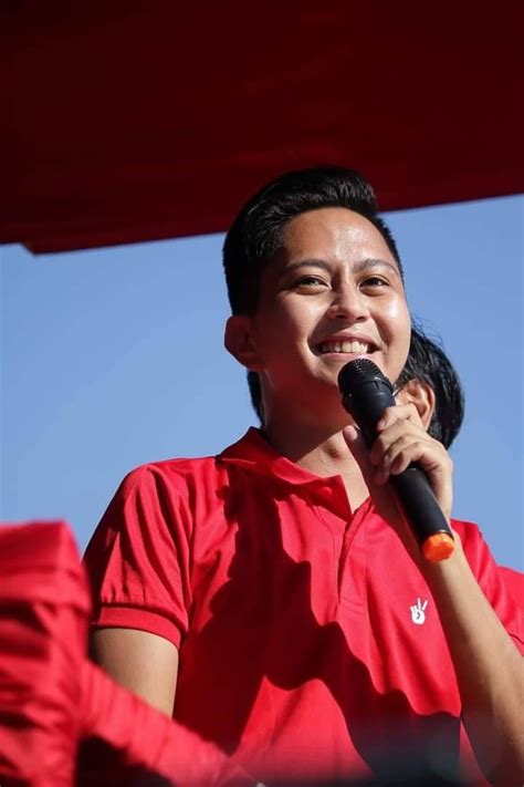 A Woman In Red Shirt Holding A Microphone