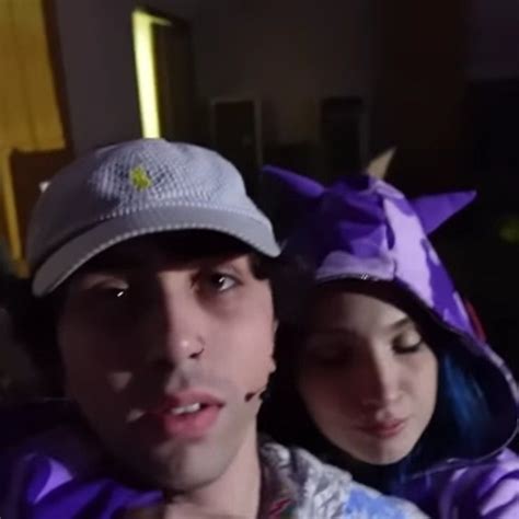 A Man And Woman Taking A Selfie In Front Of A Mirror While Wearing Hats
