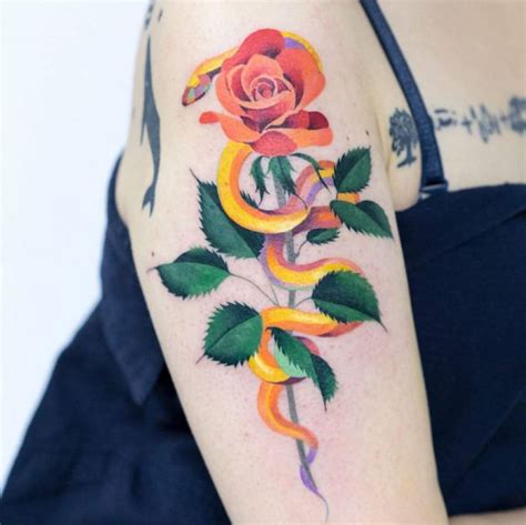 Snake And Red Rose Tattoo Located On The Upper Arm