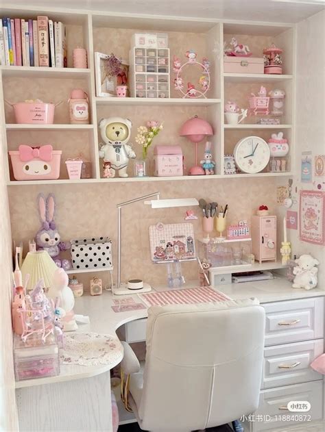 A White Desk Topped With Lots Of Shelves Filled With Pink And White