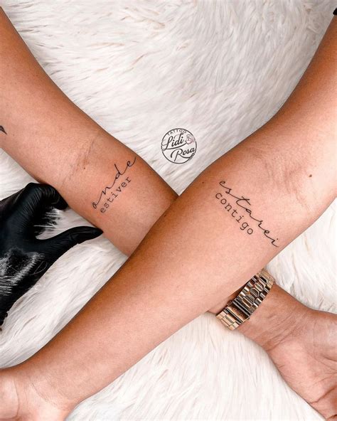 Two People With Matching Tattoos On Their Arms